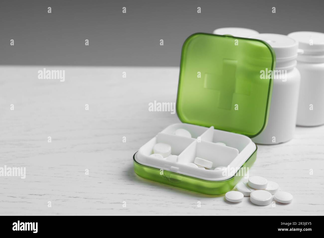 Pill box with medicaments on white wooden table. Space for text Stock ...