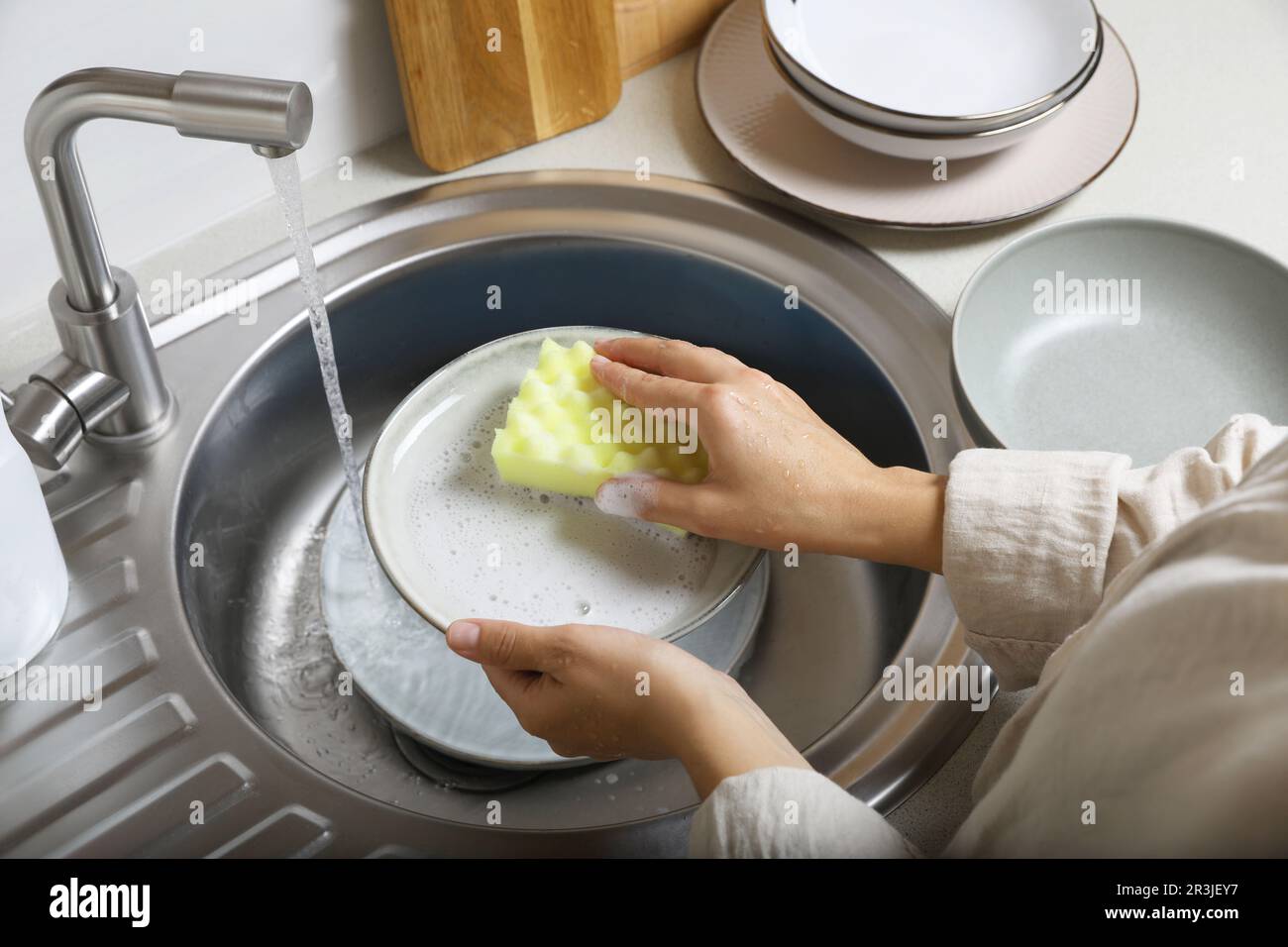 Woman washing plates kitchen sink hi-res stock photography and images ...