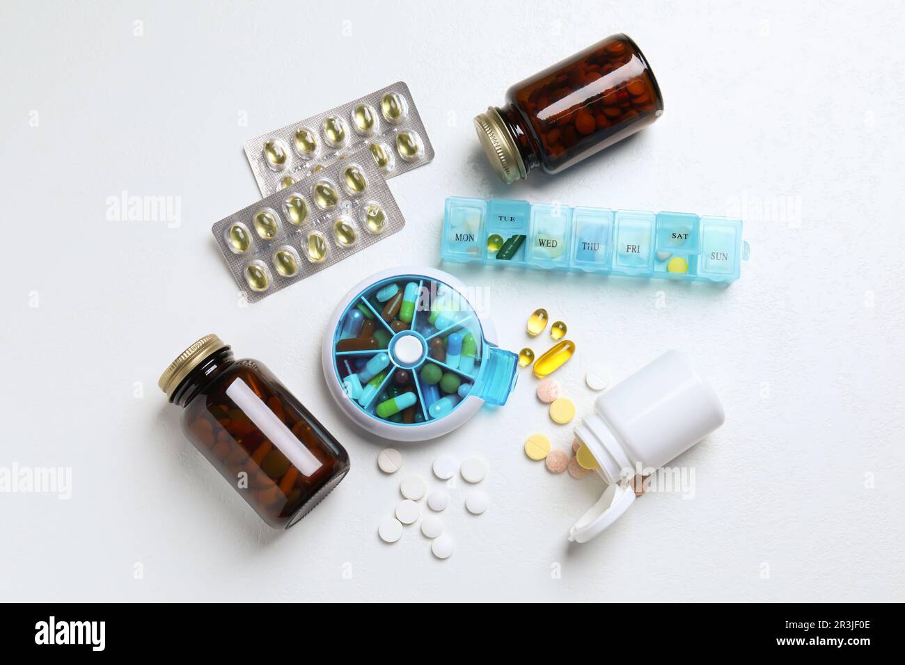 Pill boxes with medicaments on white table, flat lay Stock Photo - Alamy