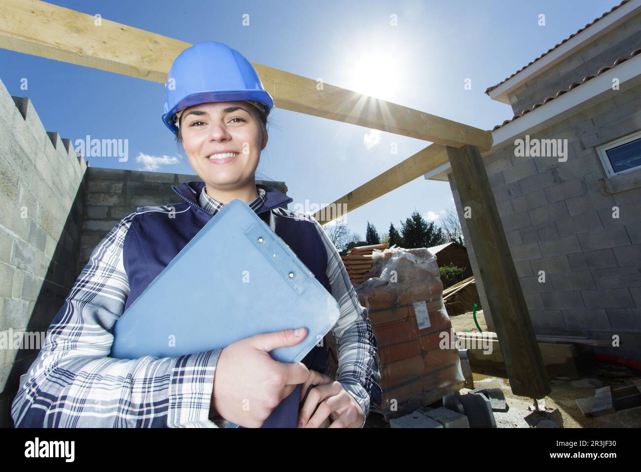 happy female builder in hardhat outdoors Stock Photo - Alamy