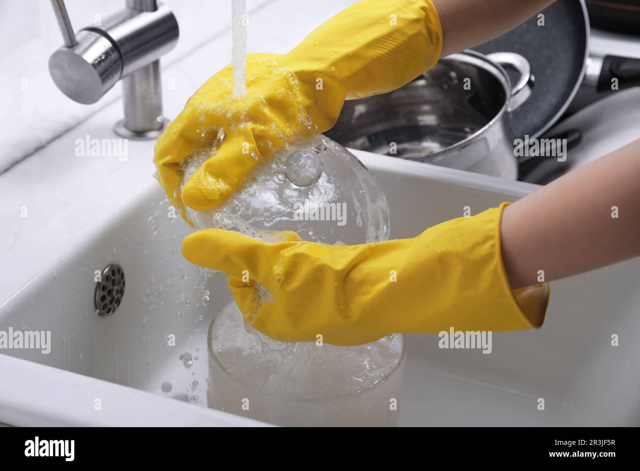 Woman washing glass pot in kitchen sink, closeup Stock Photo - Alamy