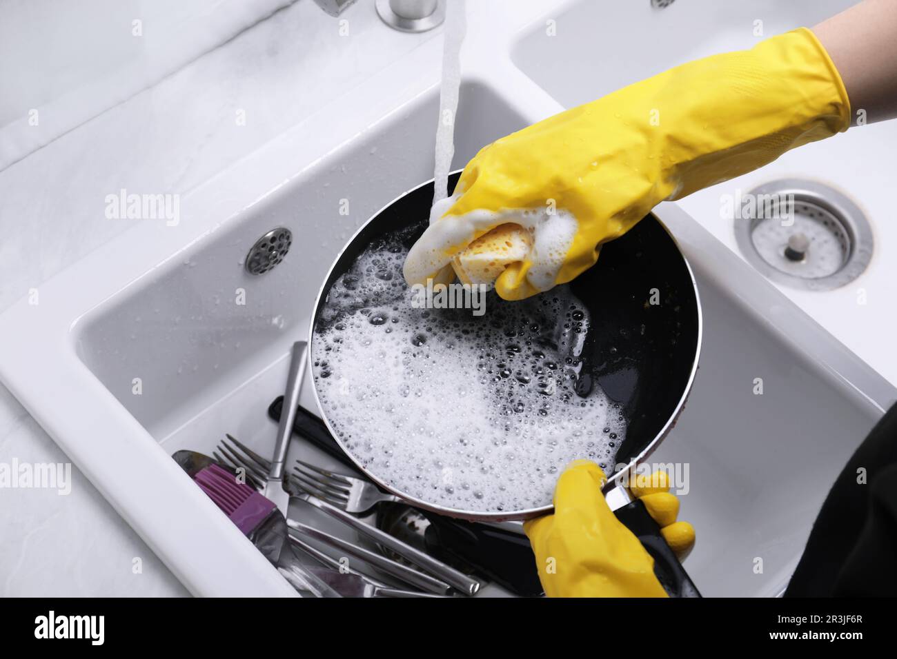 Woman washing dirty dishes in kitchen sink, closeup Stock Photo - Alamy