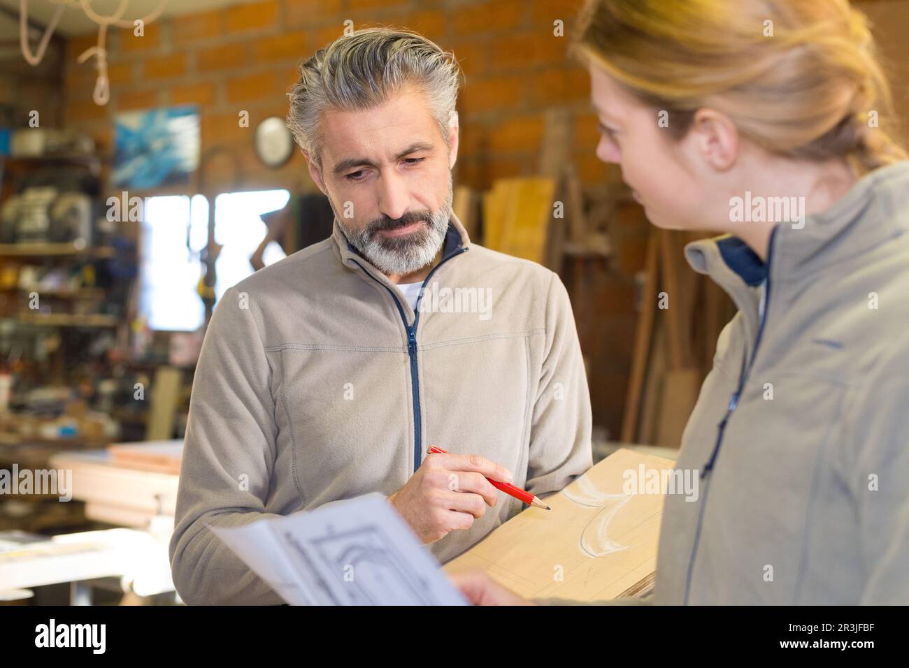 boss and worker together in a carpenters workshop Stock Photo - Alamy