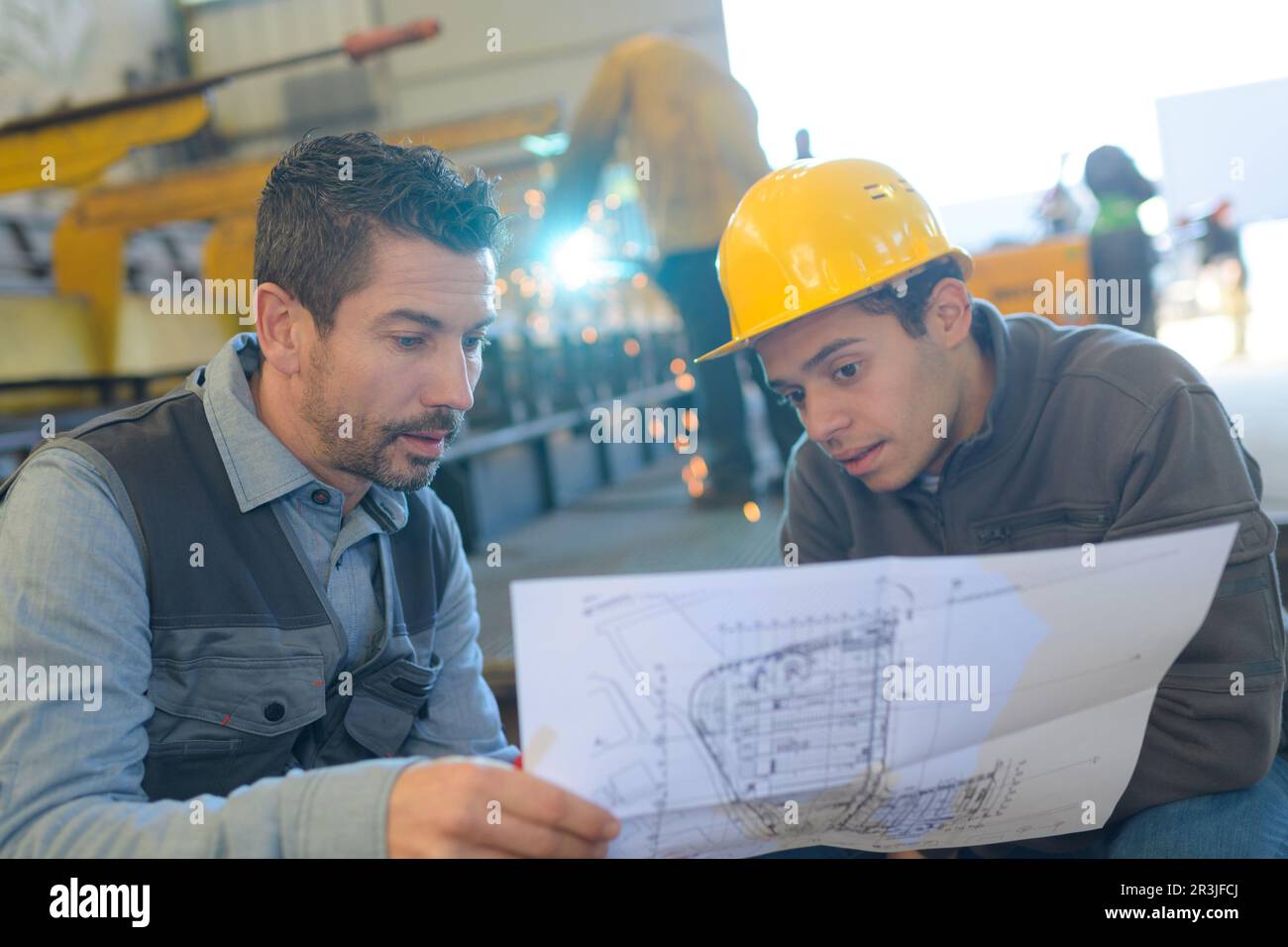 plant engineers checking a plan Stock Photo - Alamy