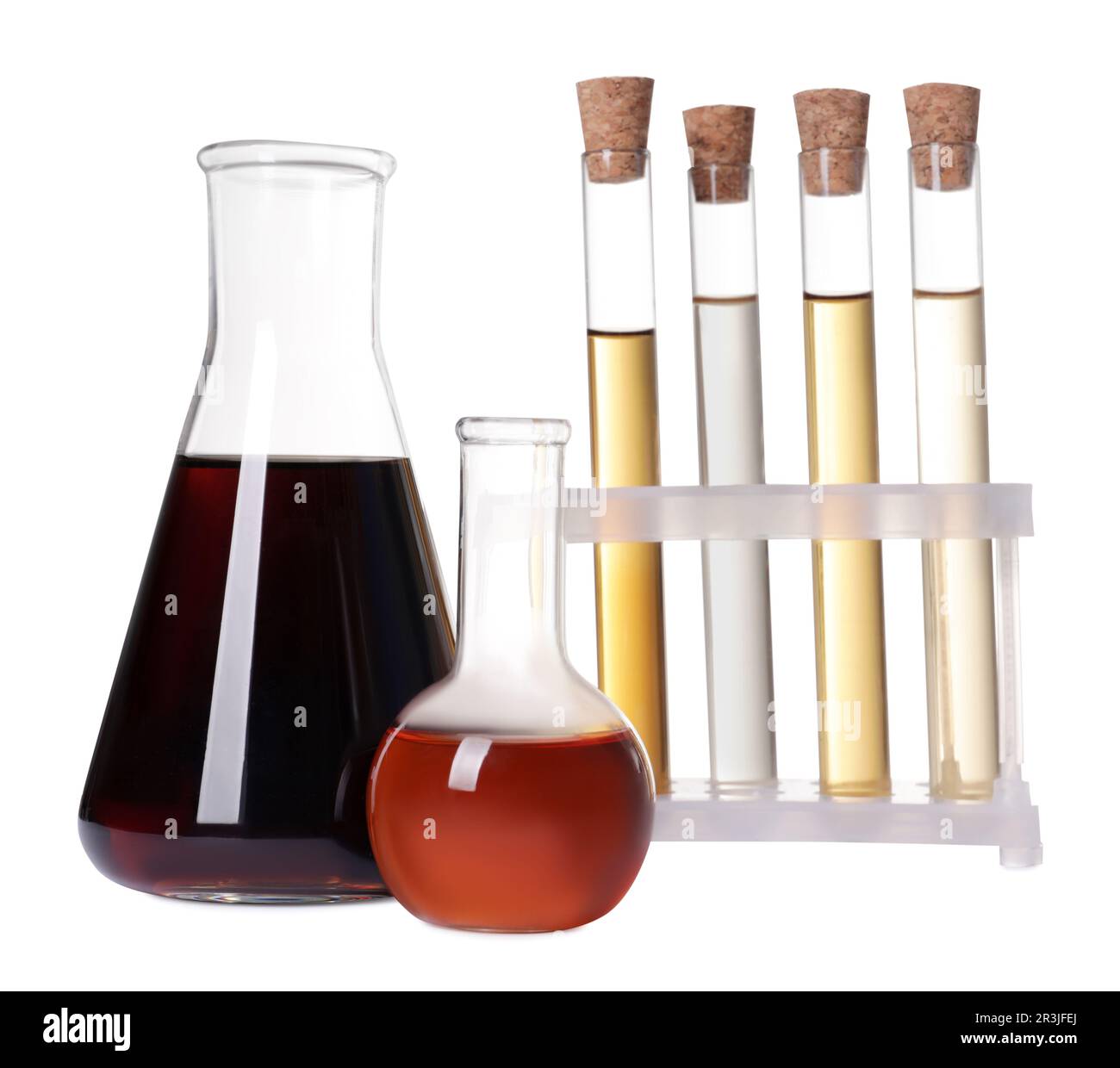 Different laboratory glassware with brown liquids on white background ...