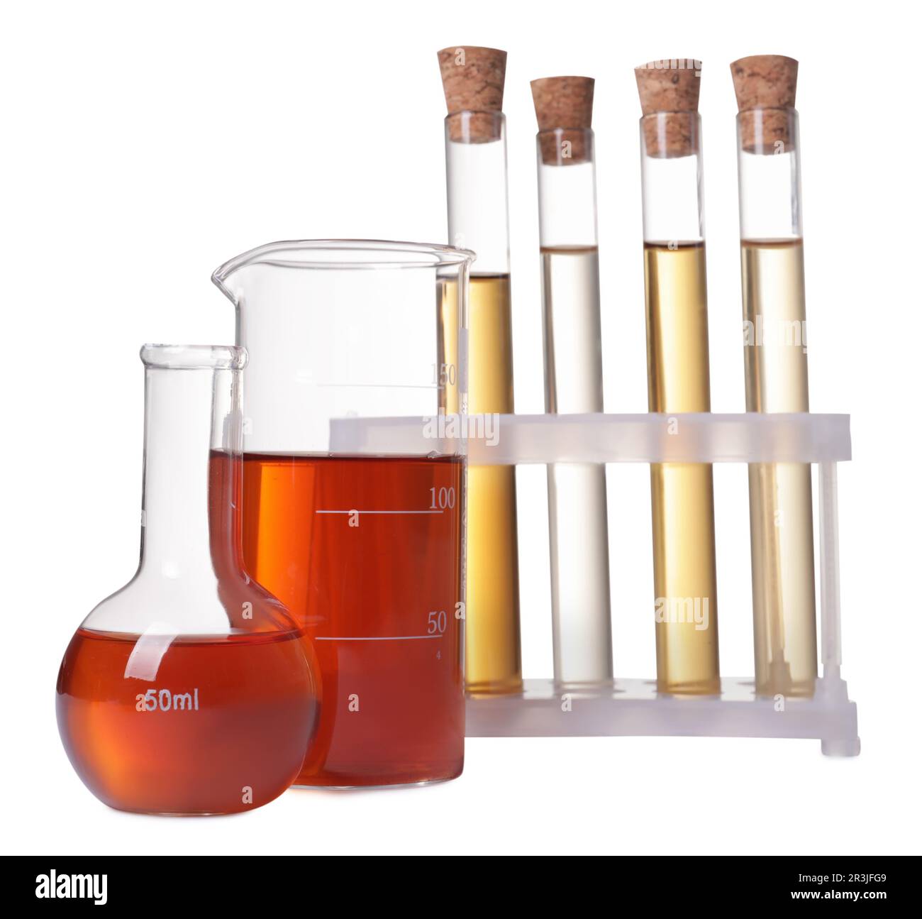 Different laboratory glassware with brown liquids on white background ...