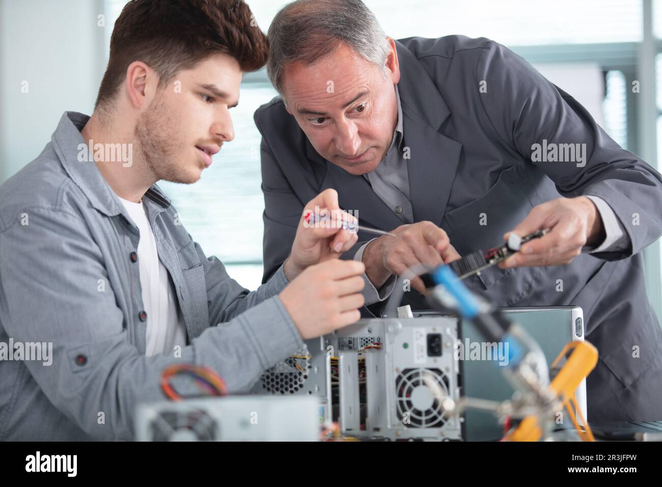 trainee technician learning how to wire up a computer Stock Photo - Alamy
