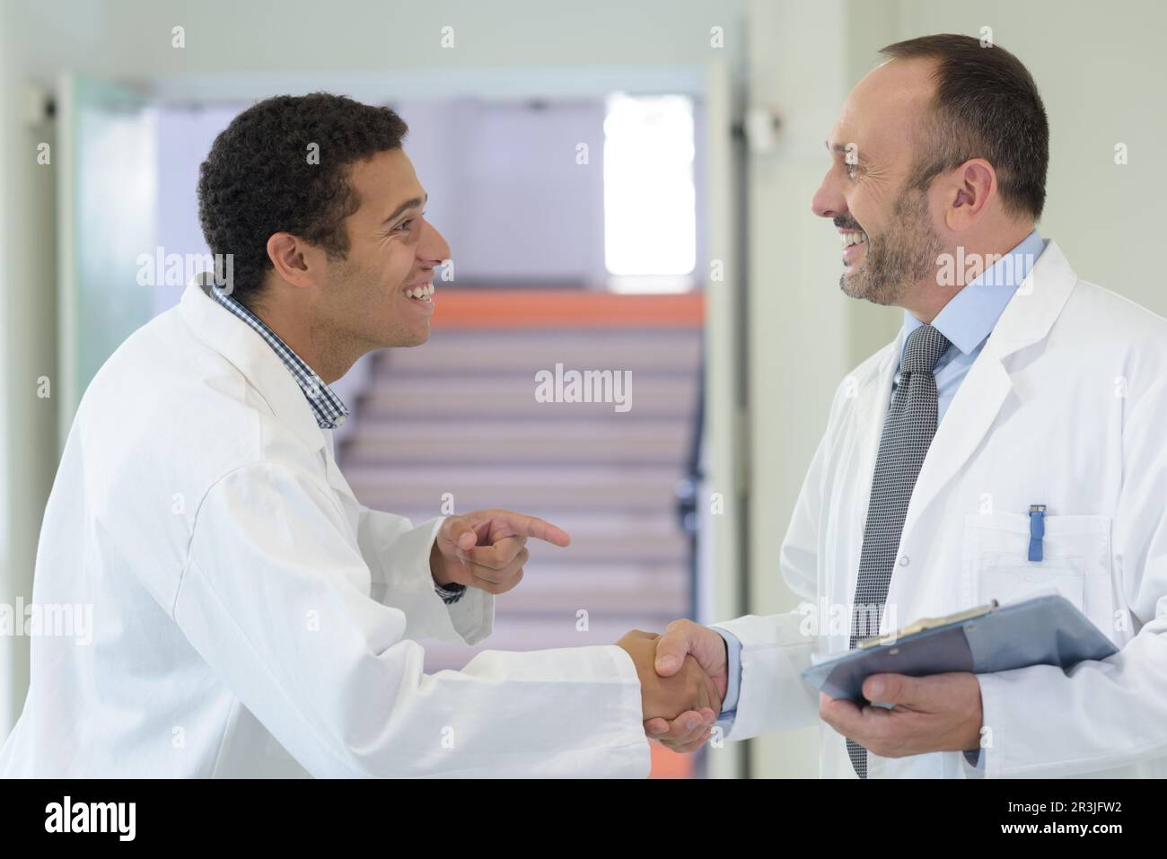 happy doctors doing a handshake Stock Photo - Alamy