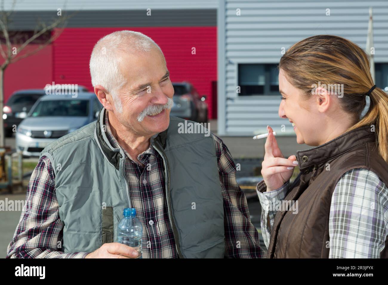 female and male builder smoking a cigarette Stock Photo - Alamy