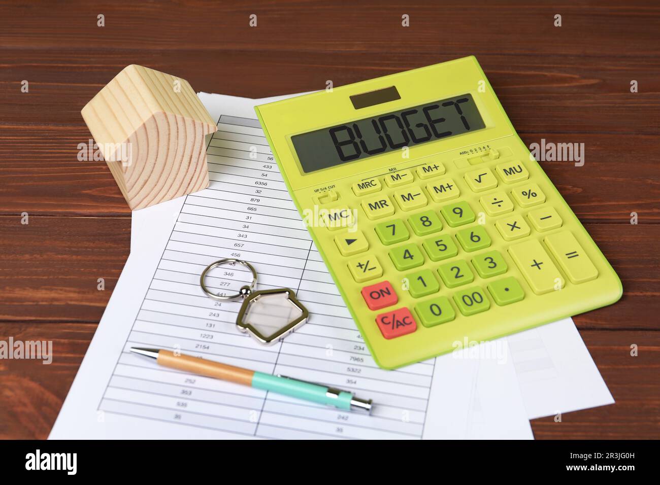 Budget plan. Calculator, house model and documents on wooden table ...