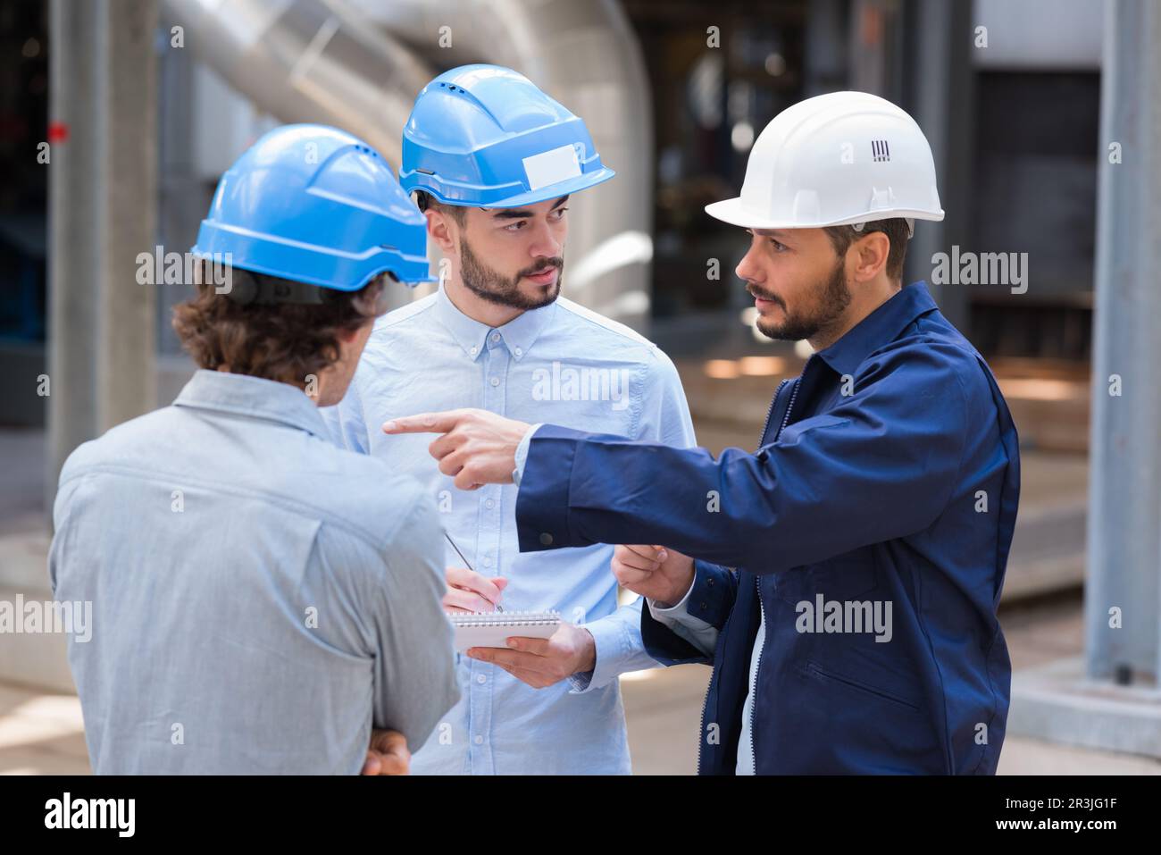Engineers pointing discussing construction site hi-res stock ...