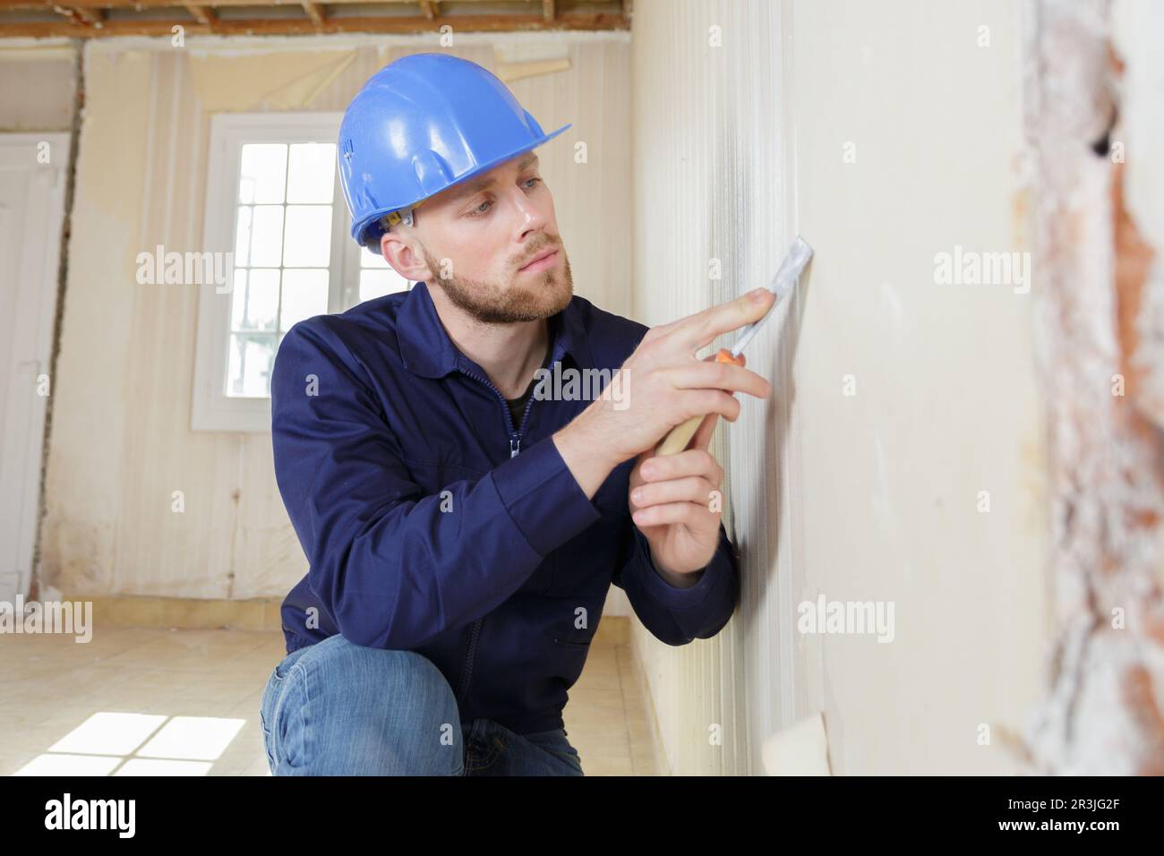 young plasterer plastering the walls Stock Photo - Alamy