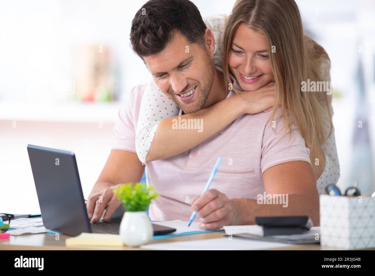 woman embracing boyfriend using computer Stock Photo - Alamy