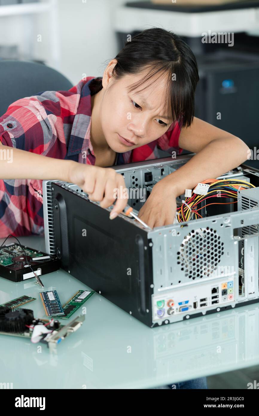 a woman disassembling computer motherboard Stock Photo - Alamy