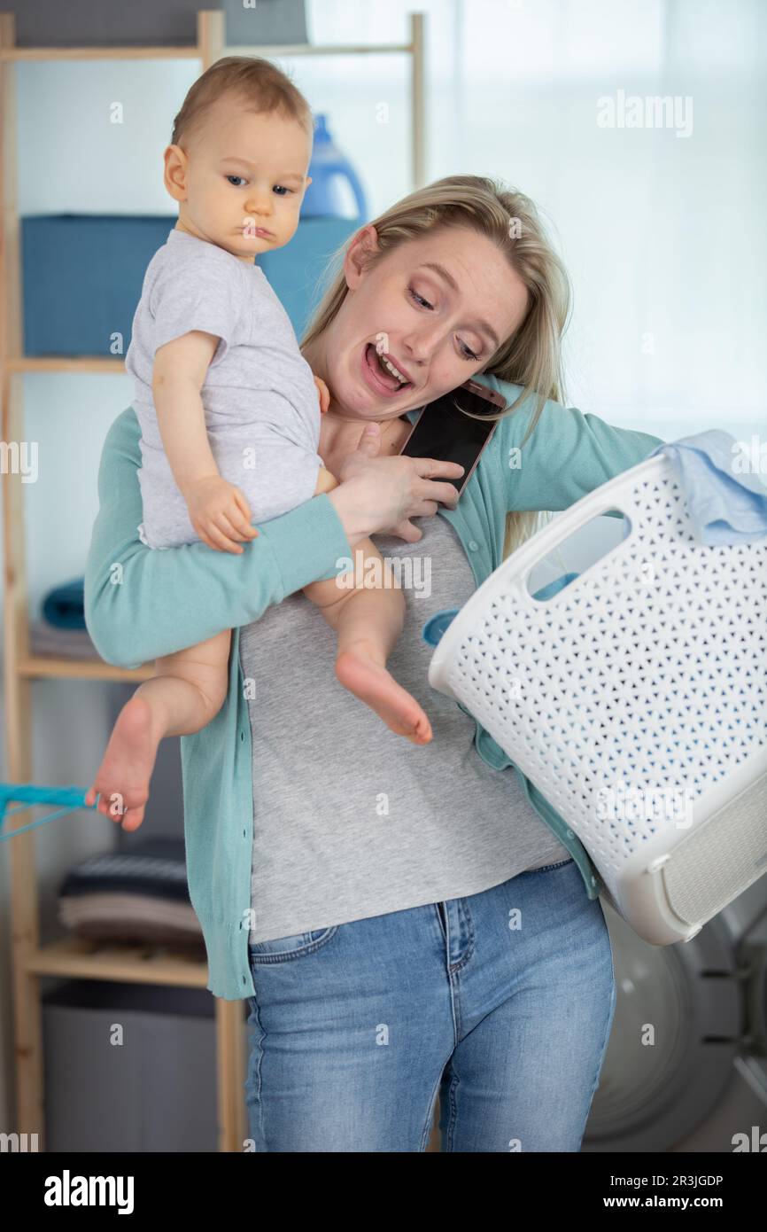 screaming young mother fed up with doing the laundry Stock Photo - Alamy