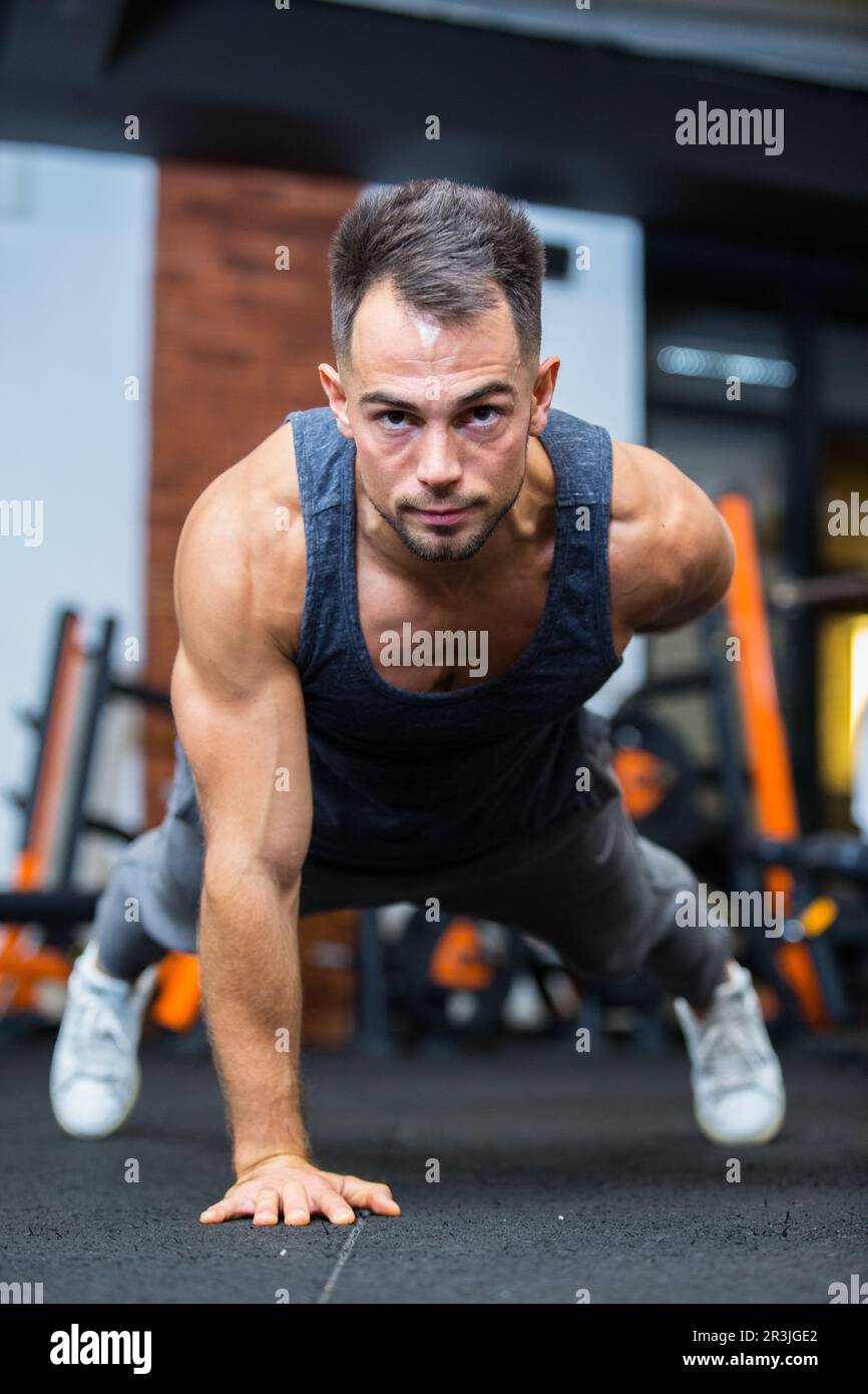 young fit male doing static exercise Stock Photo - Alamy
