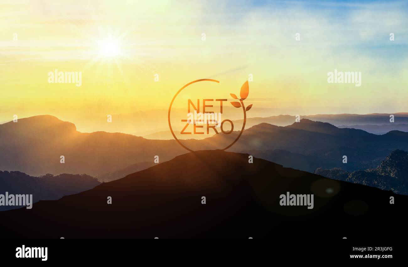 Net Zero sign on top of mountain at sunset, surrounded by eco-friendly ...