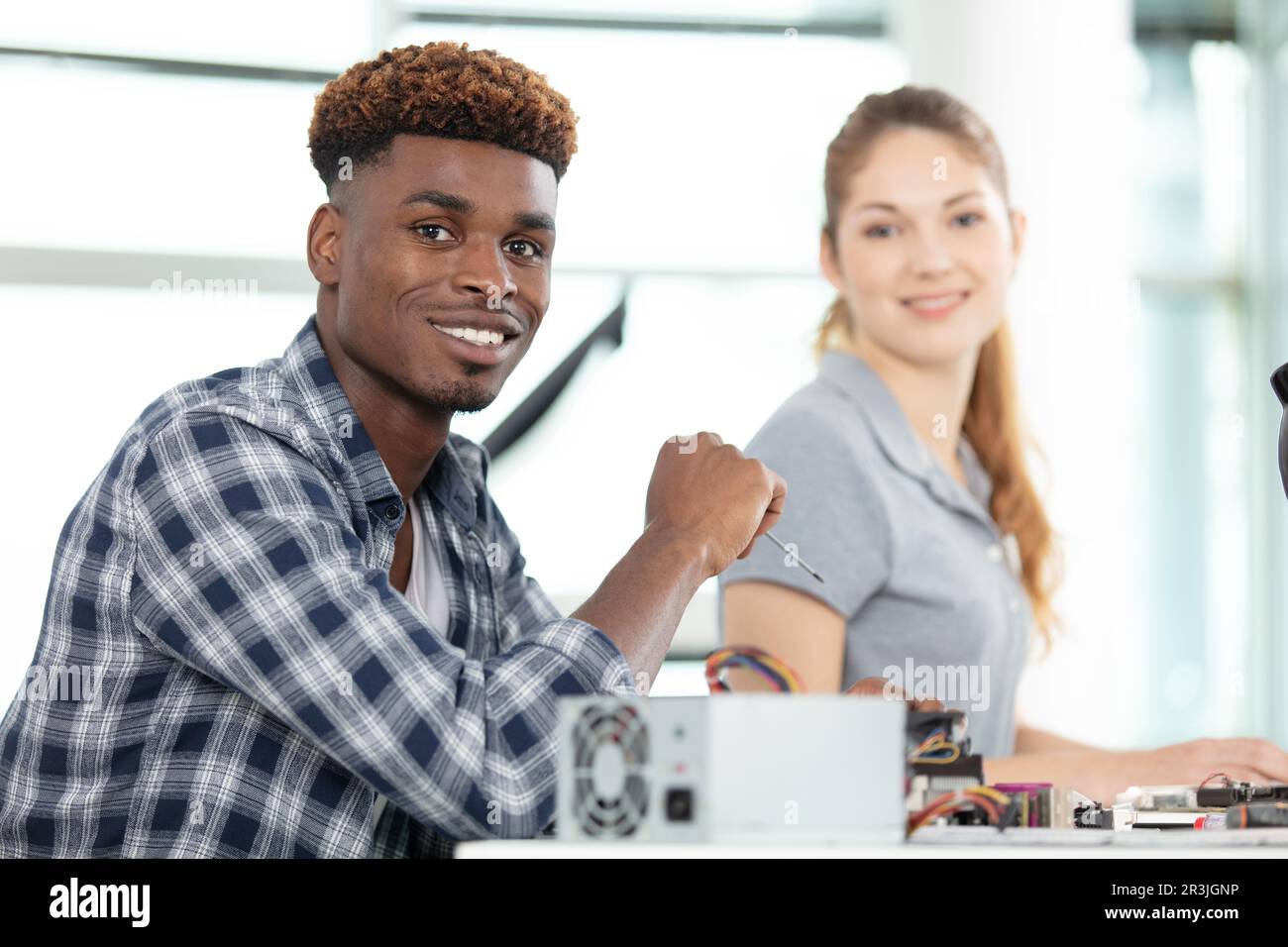 female and male technicians fixing devices Stock Photo - Alamy