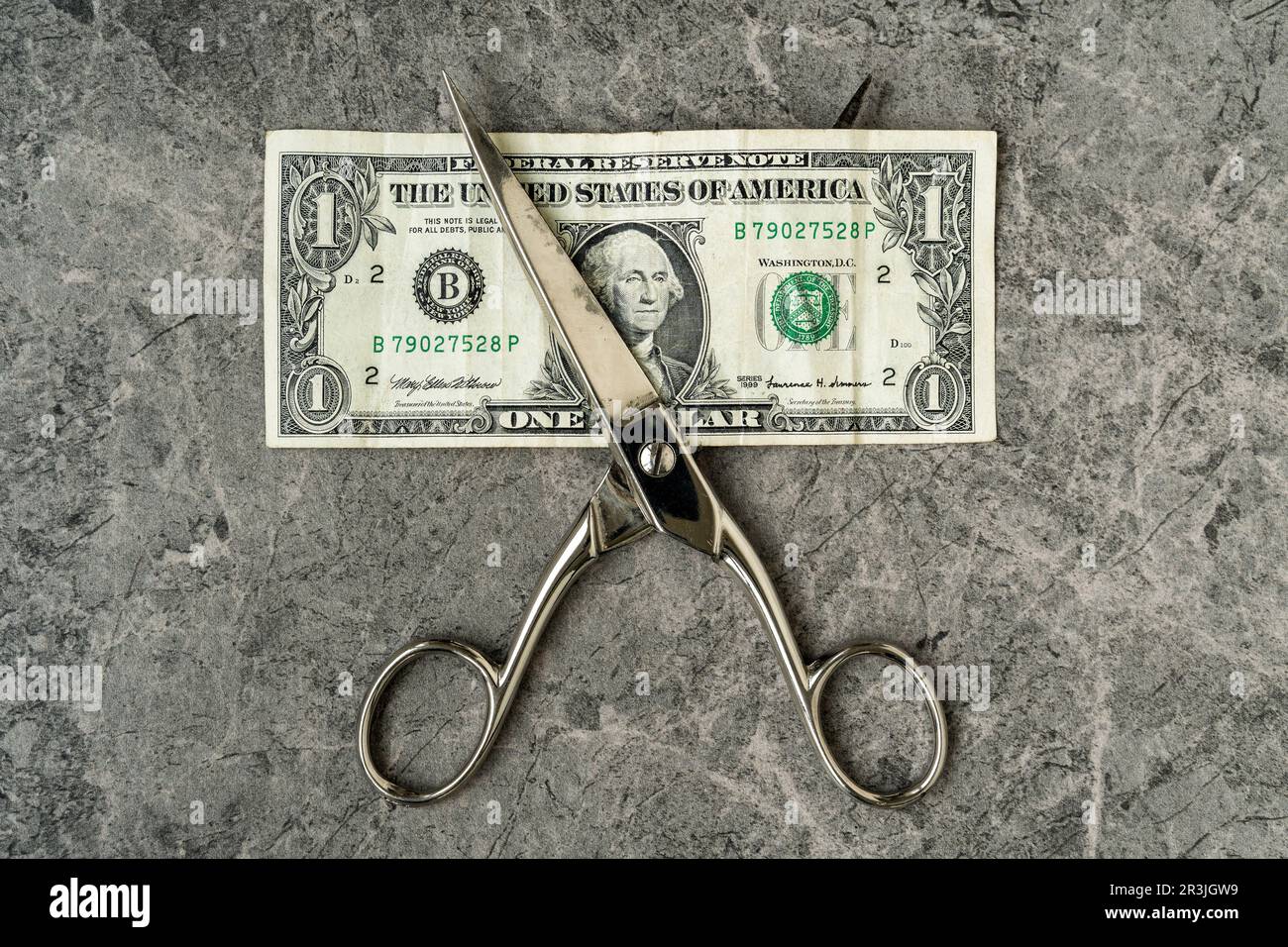 One Dollar banknote is cut with scissors Stock Photo - Alamy