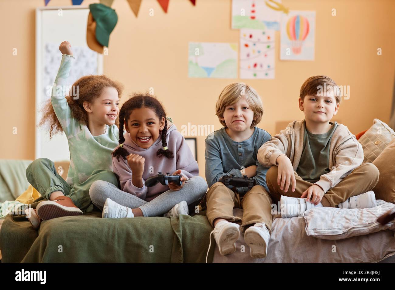 Portrait of cute black girl winning videogame over boys while playing ...