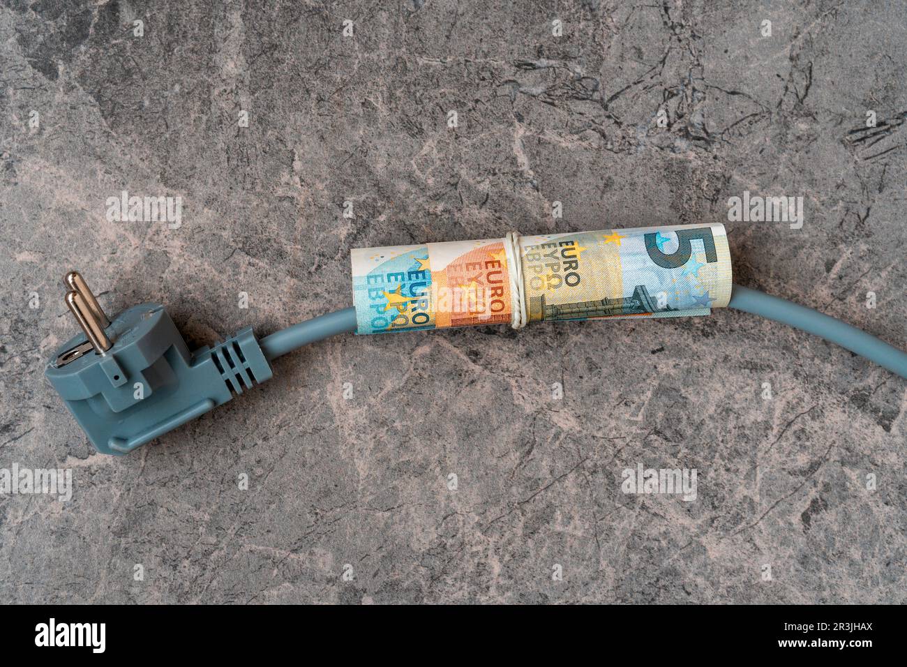 Electric cord with a roll of Euro currency Stock Photo - Alamy