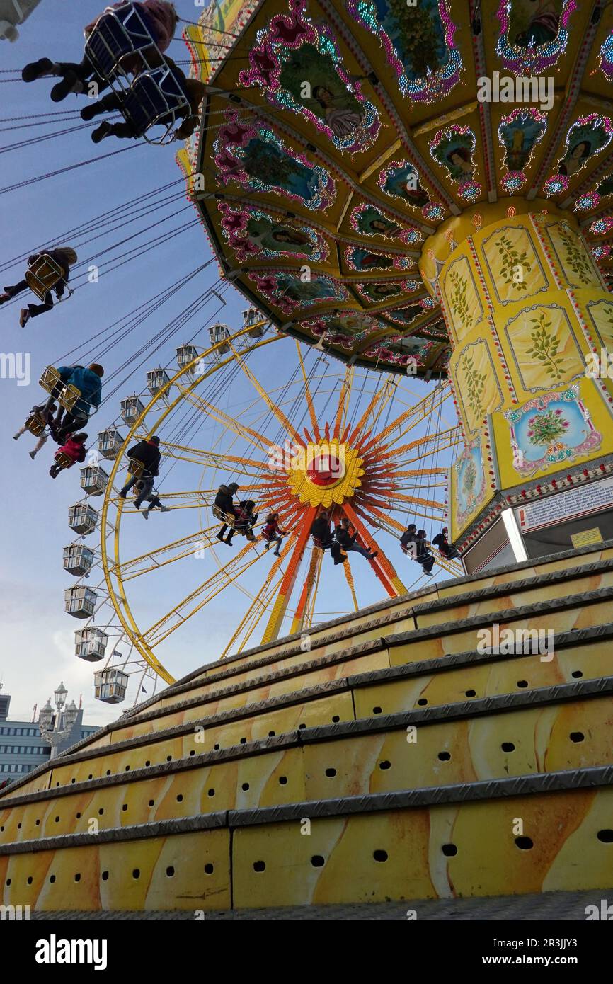 Chain carousel and Ferris wheel on the Hamburg Cathedral Stock Photo ...