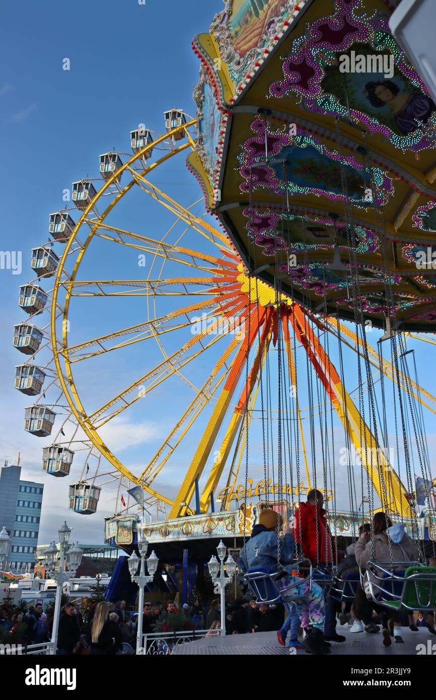 Chain carousel and Ferris wheel on the Hamburg Cathedral Stock Photo ...