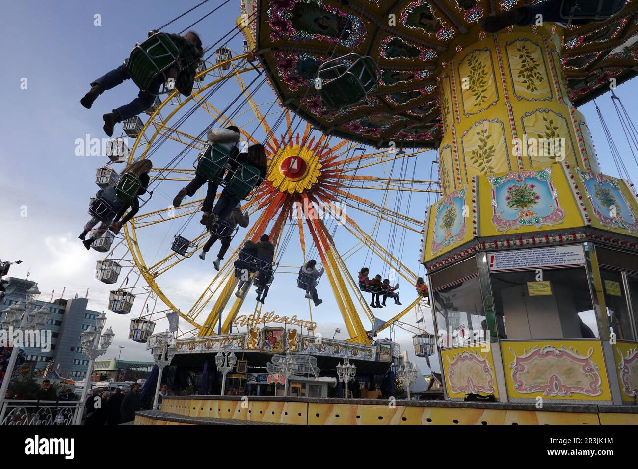 Chain carousel and Ferris wheel on the Hamburg Cathedral Stock Photo ...