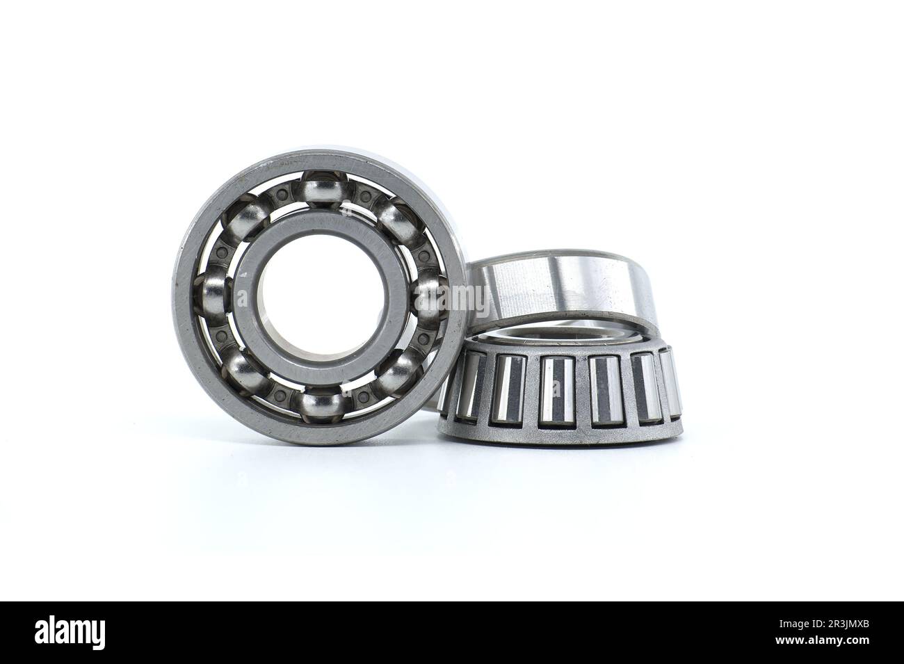 Ball bearing and tapered roller bearing isolated on white background ...