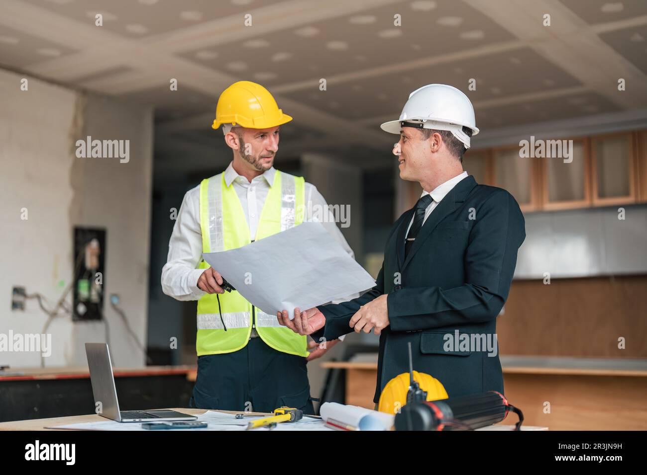 Professional construction engineers team using blueprint of project ...