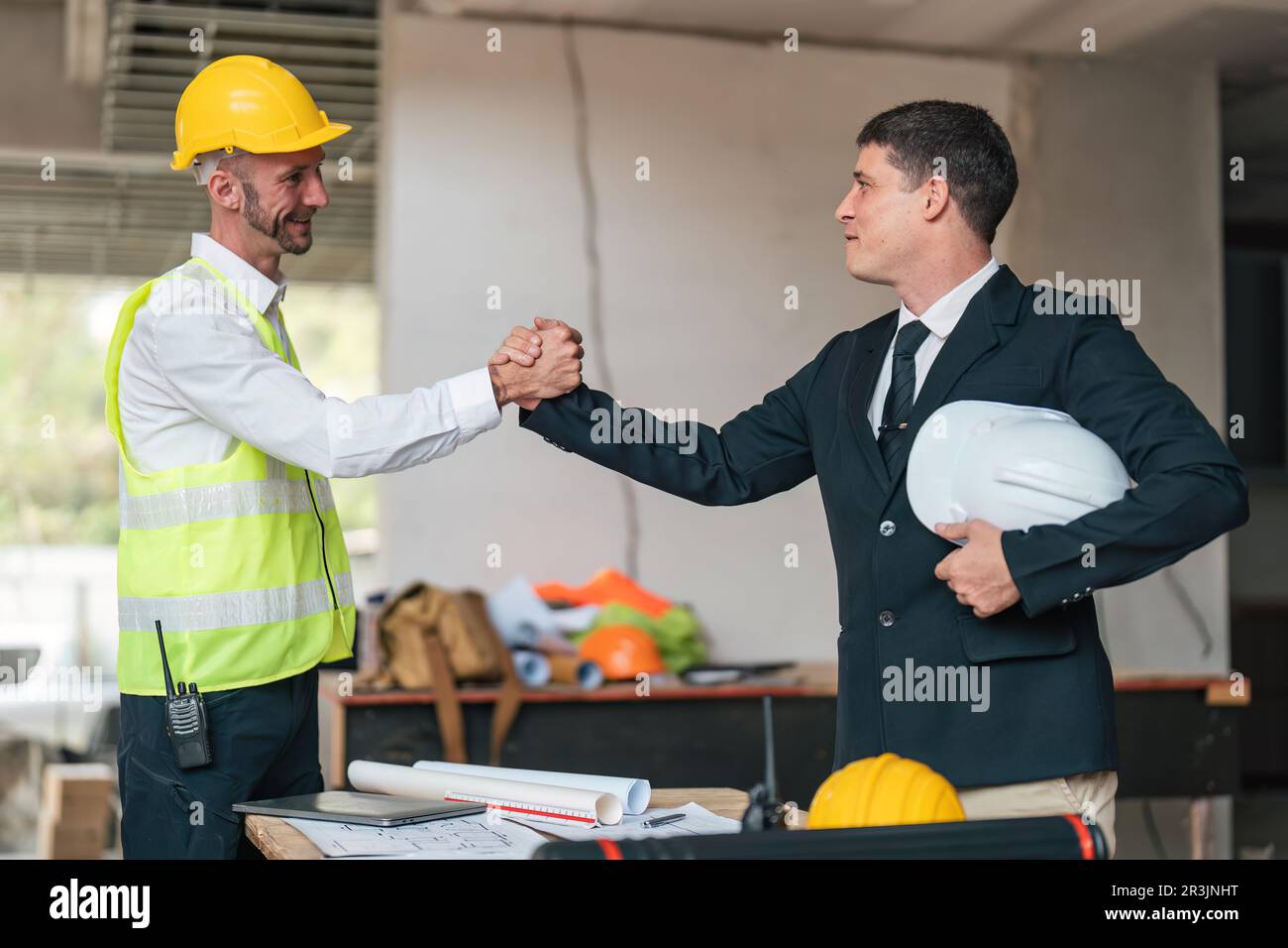 Happy young civil engineer manager and architects handshaking at ...