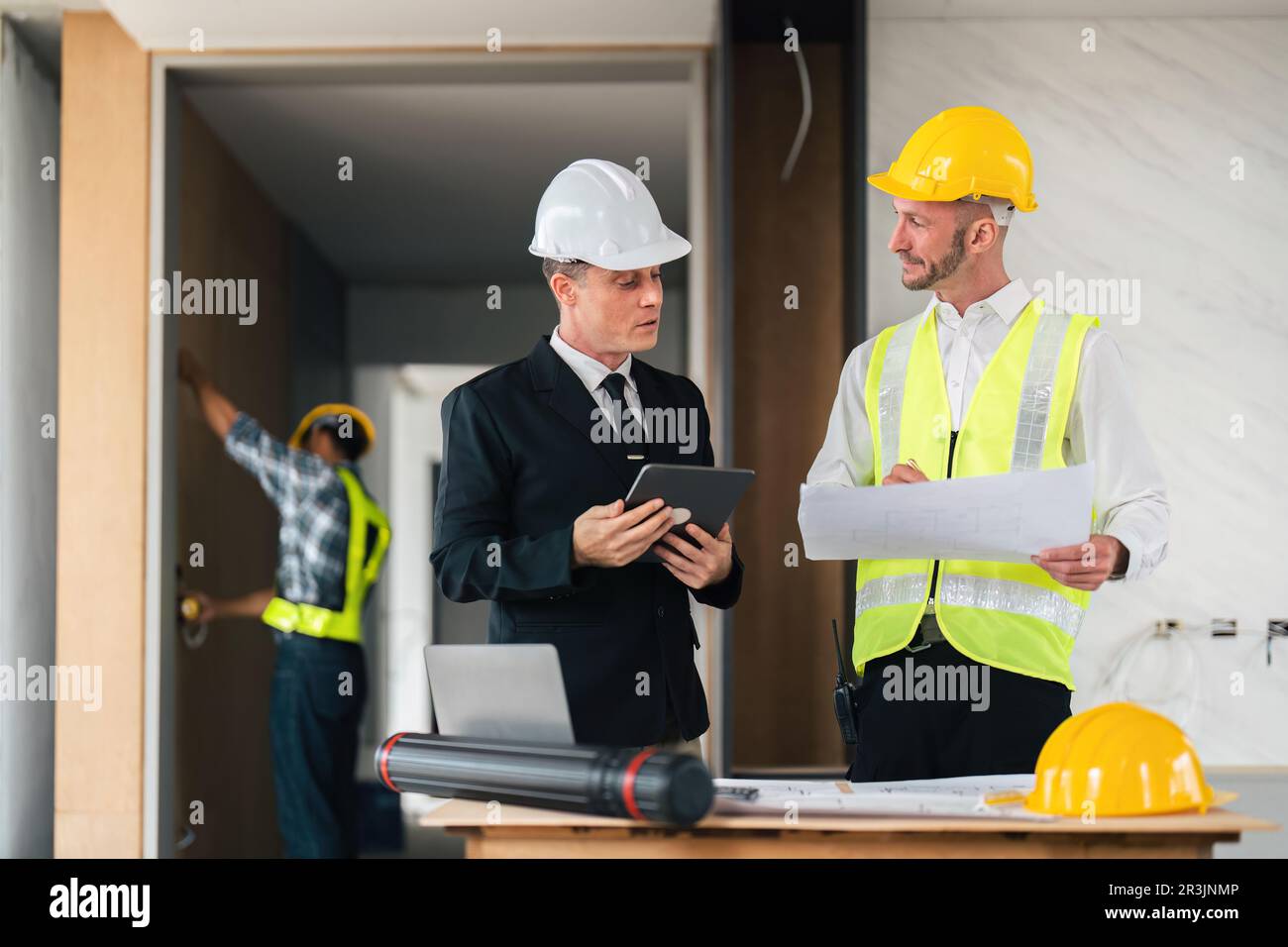 Professional construction engineers team using blueprint of project ...