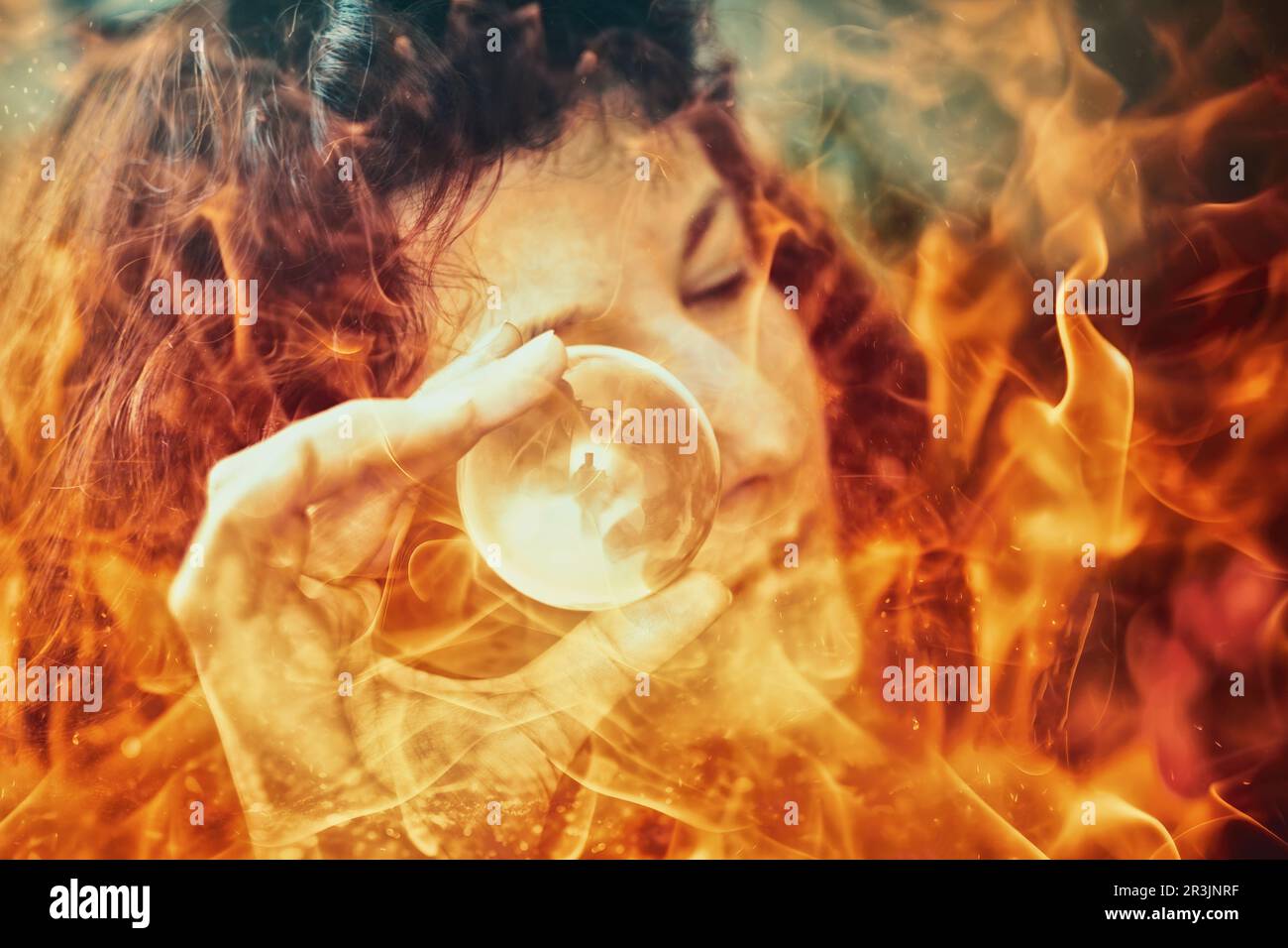 woman holding glass sphere, fire effect Stock Photo - Alamy