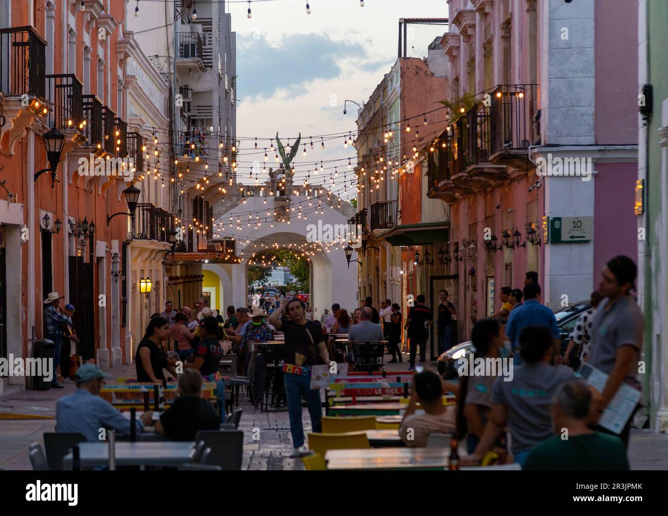 Restaurant tables in street at night with hanging lights, Campeche city ...