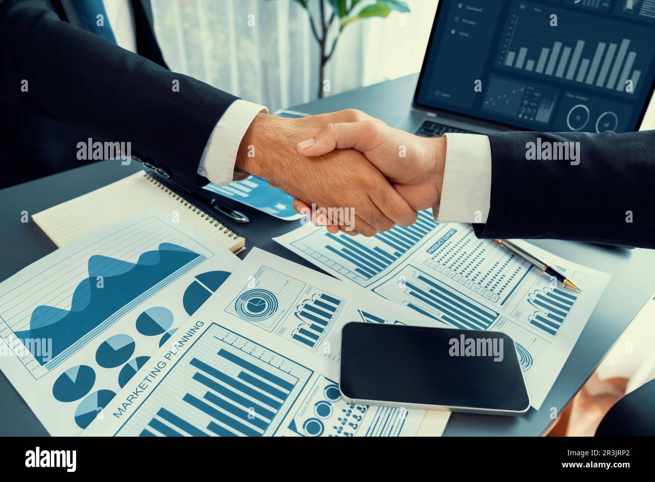 Closeup professional businessman shaking hands over desk in modern ...
