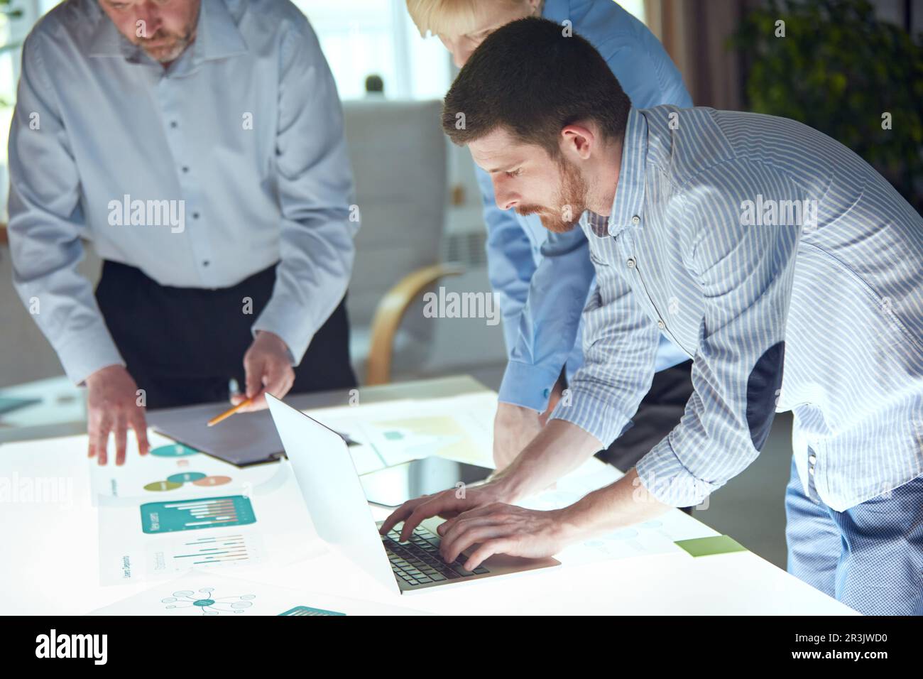 Team analyzing investment graph of money brainstorming and discussing ...