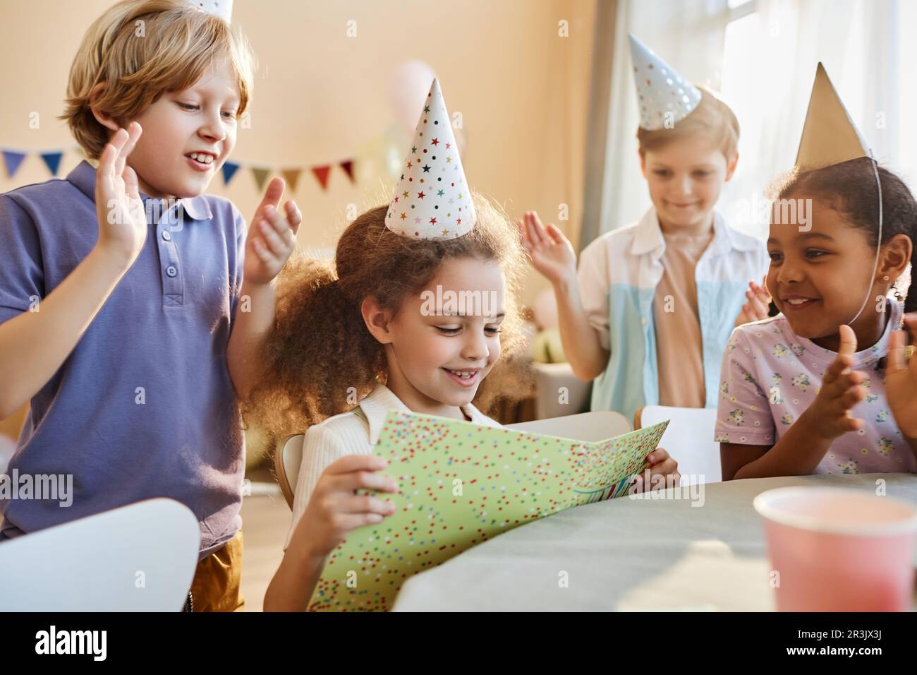 Diverse group of happy children at Birthday party with cute girl ...