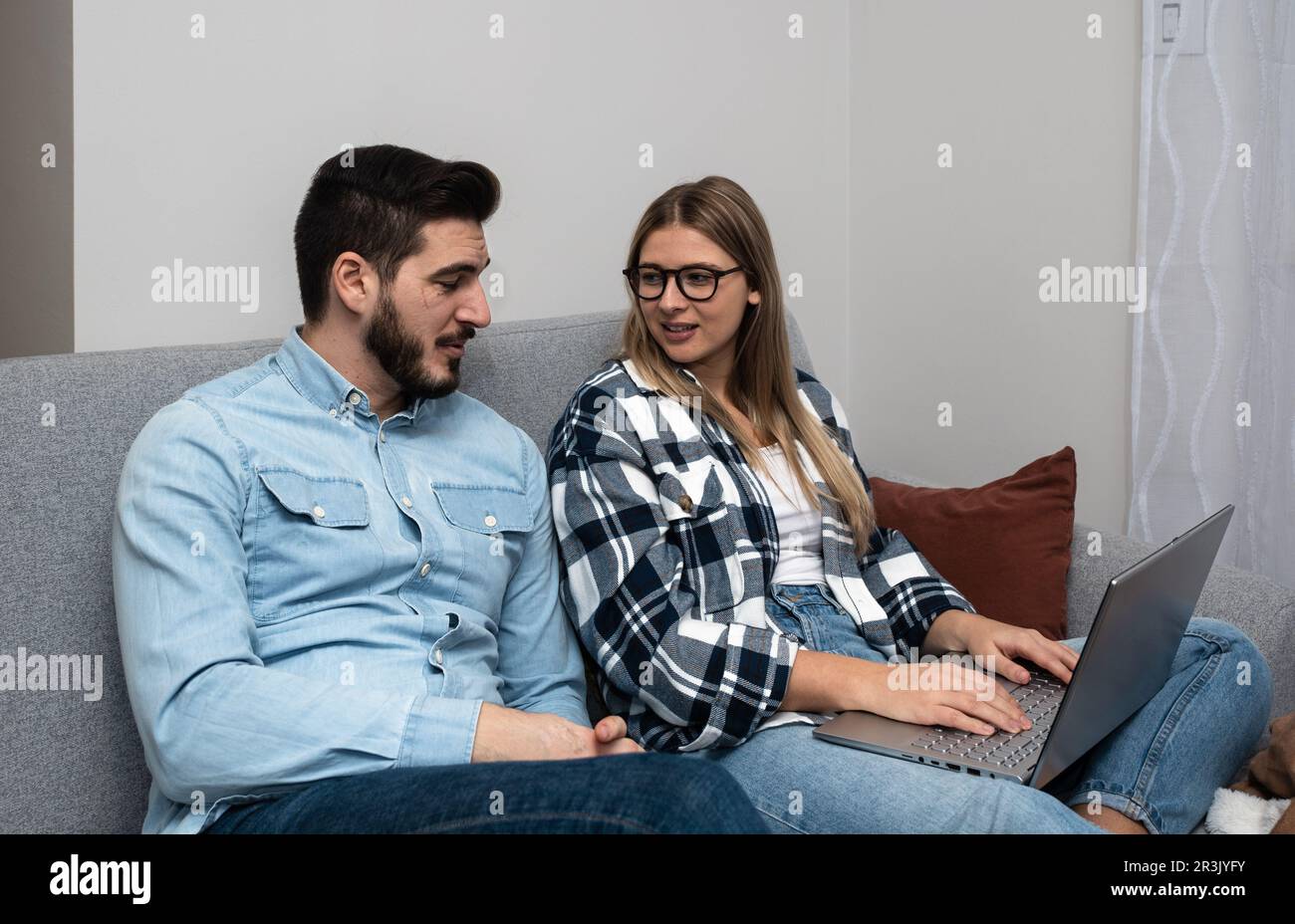 Young happy lovely couple planning budget together at home, writing ...
