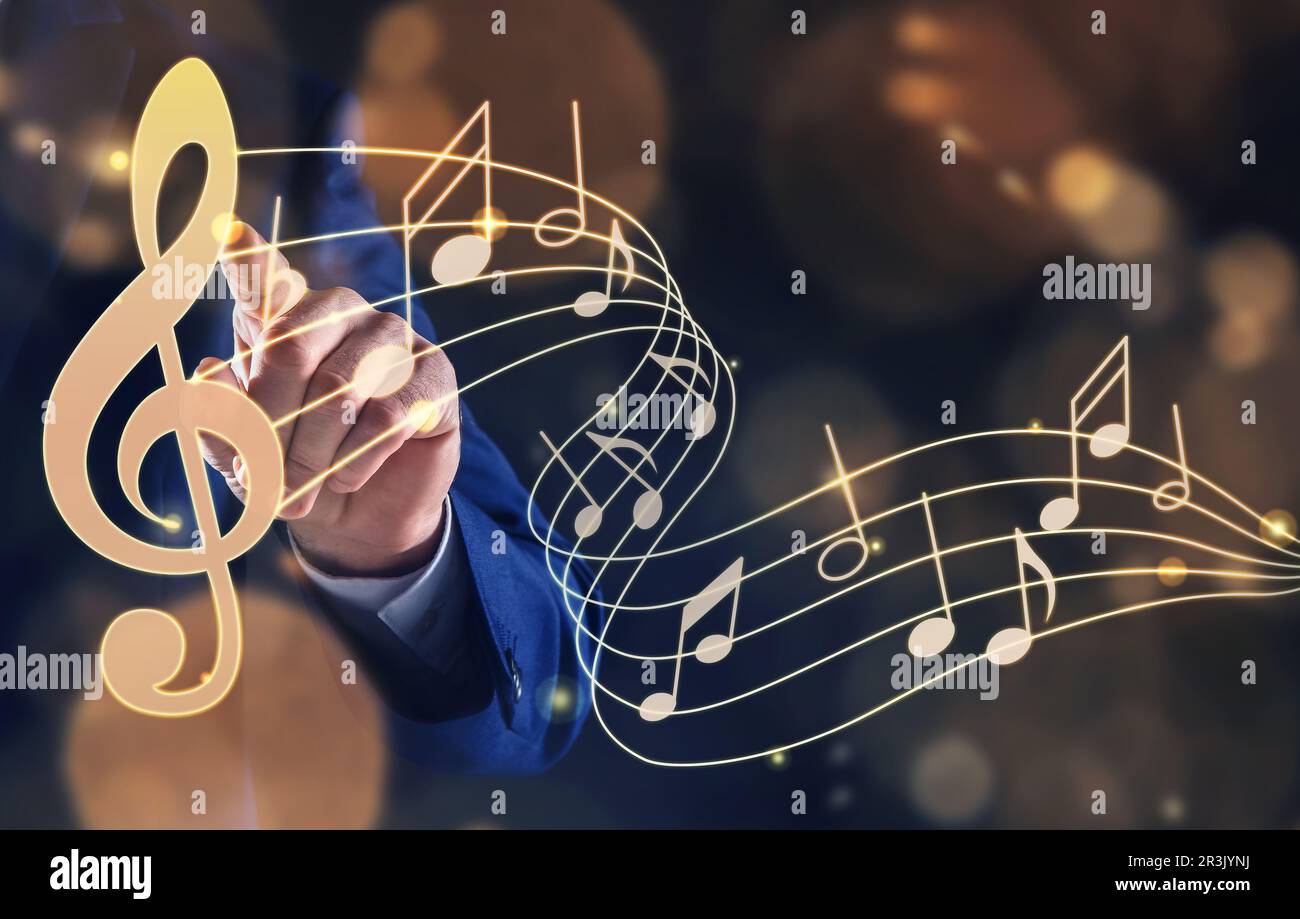 Musician pointing at staff with music notes and treble clef on color ...