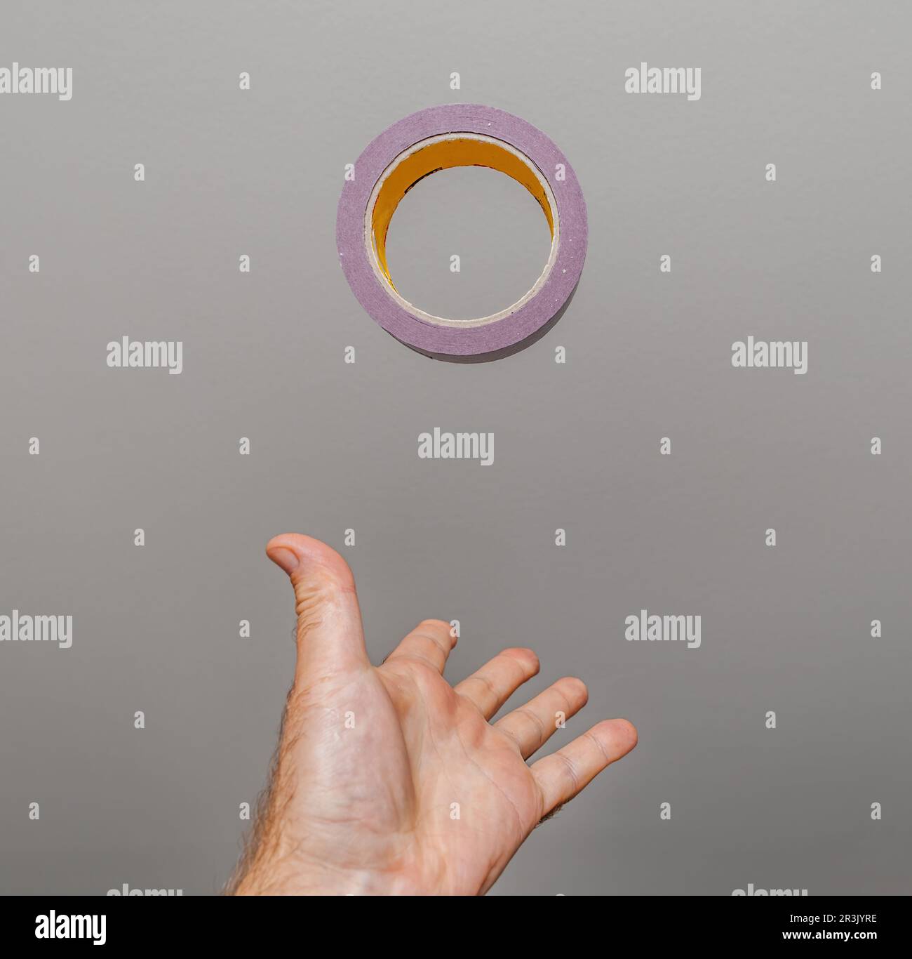 Hand about to get a roll of scotch wich is floating levitating in the ...