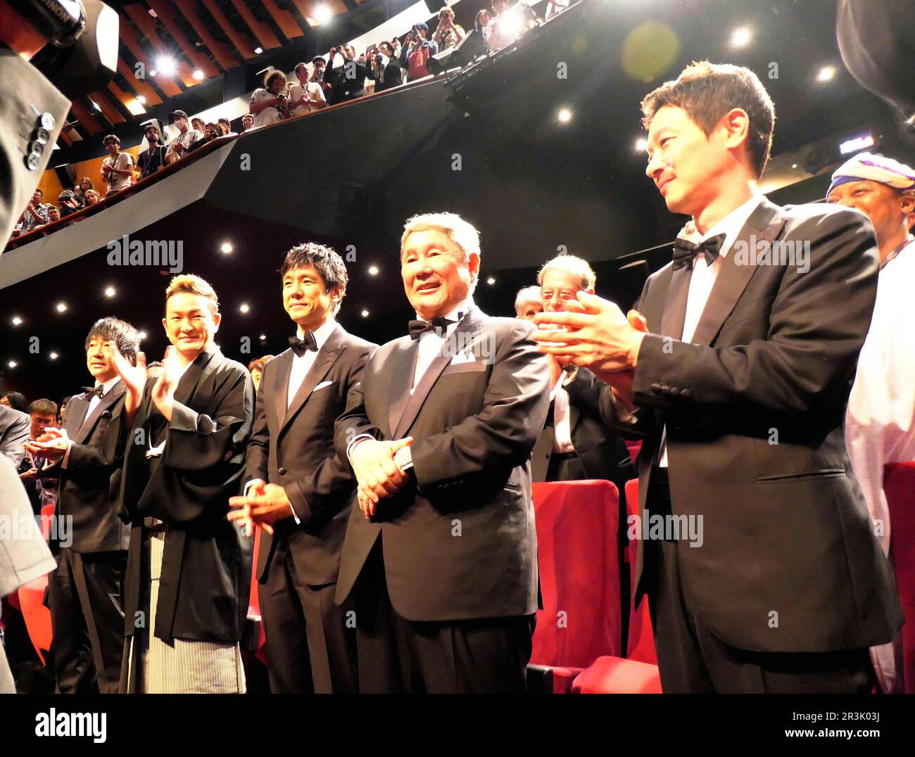 Japanese film director Kitano Takeshi (2nd from R) receives a standing ...