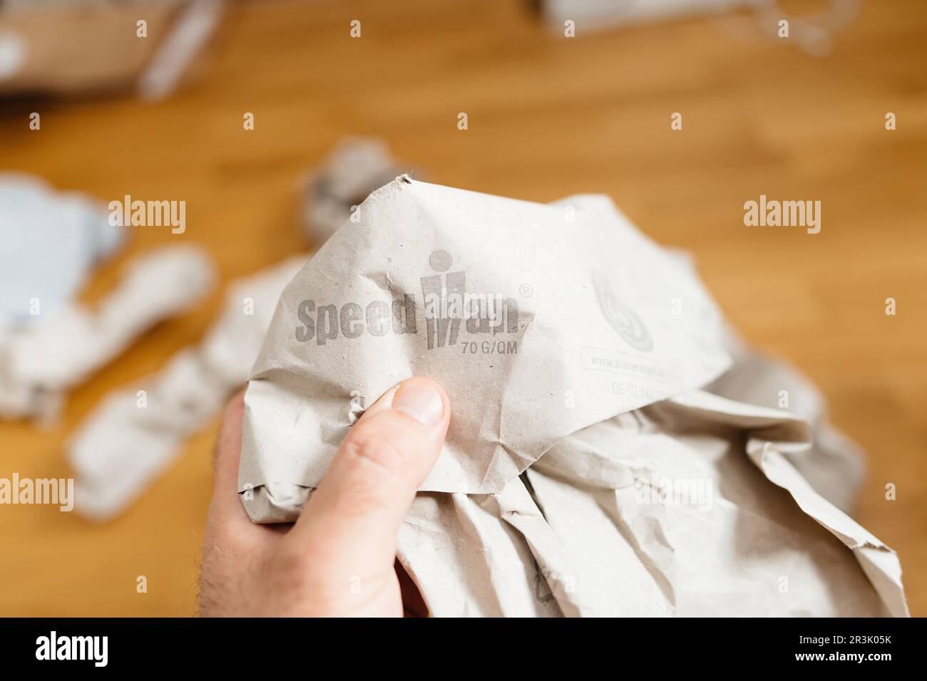 Paris, France - May 22, 2023: A male hand holds a Blauer-Engel paper ...