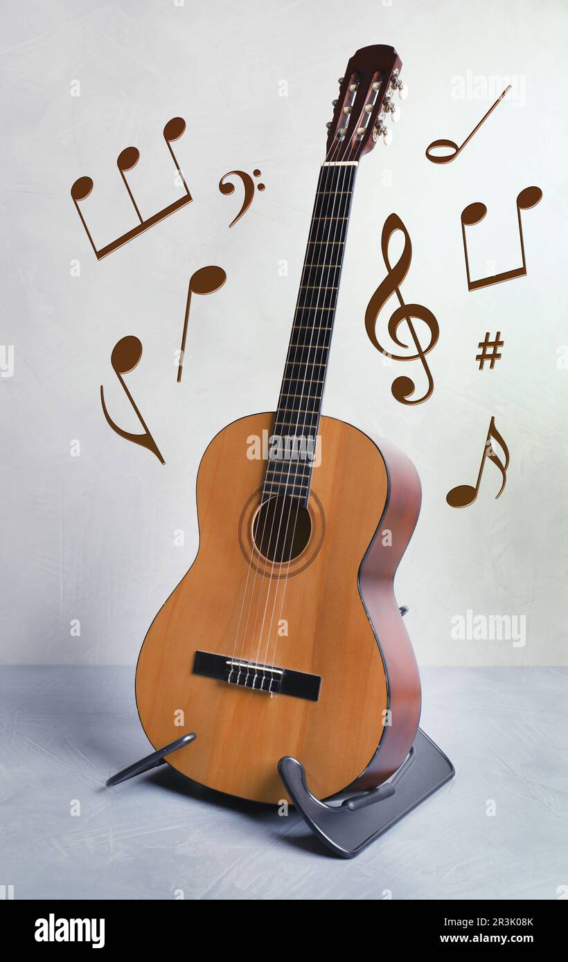 Acoustic guitar, music notes and other musical symbols indoors Stock ...