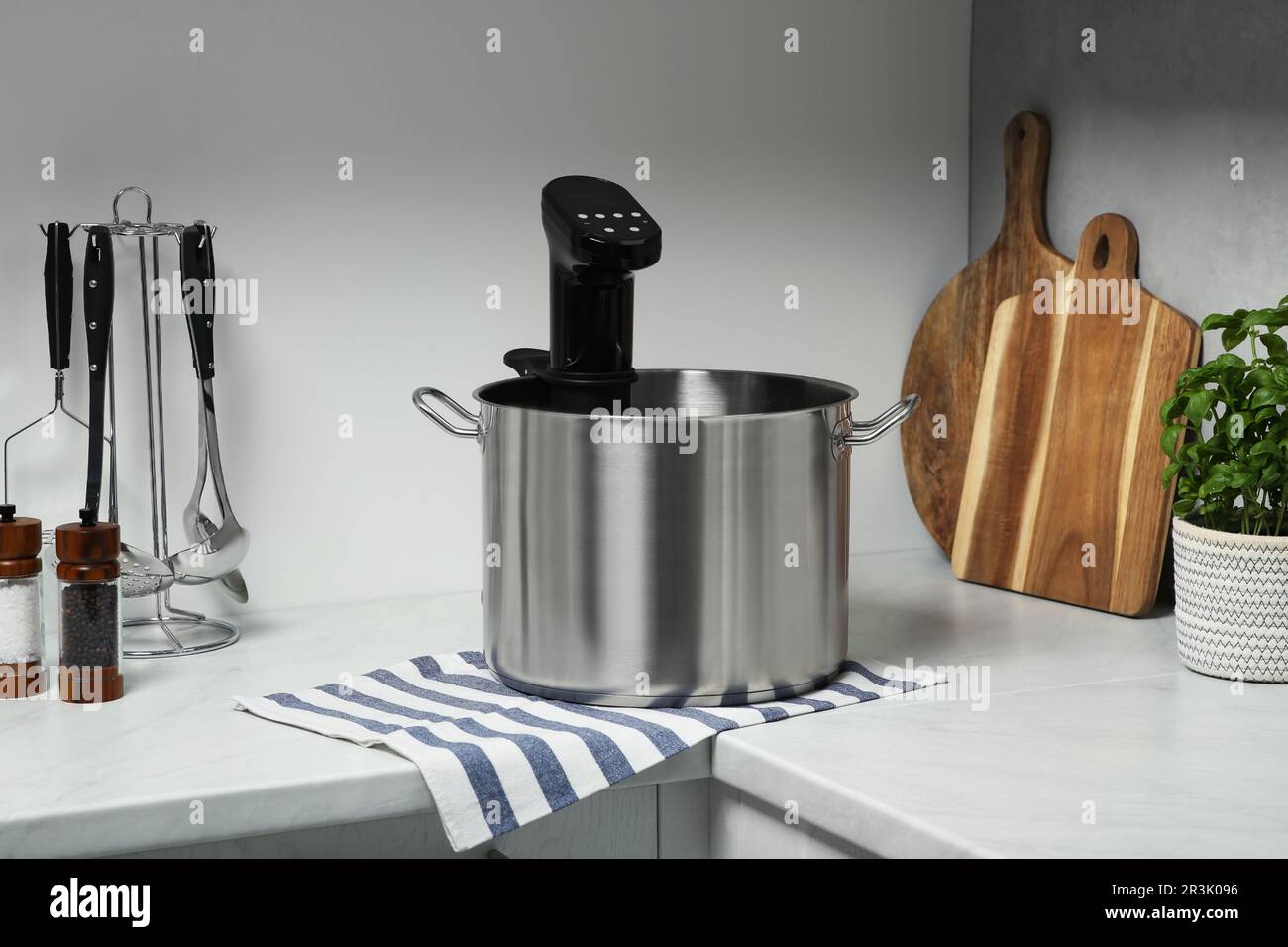 Pot with sous vide cooker in kitchen. Thermal immersion circulator ...