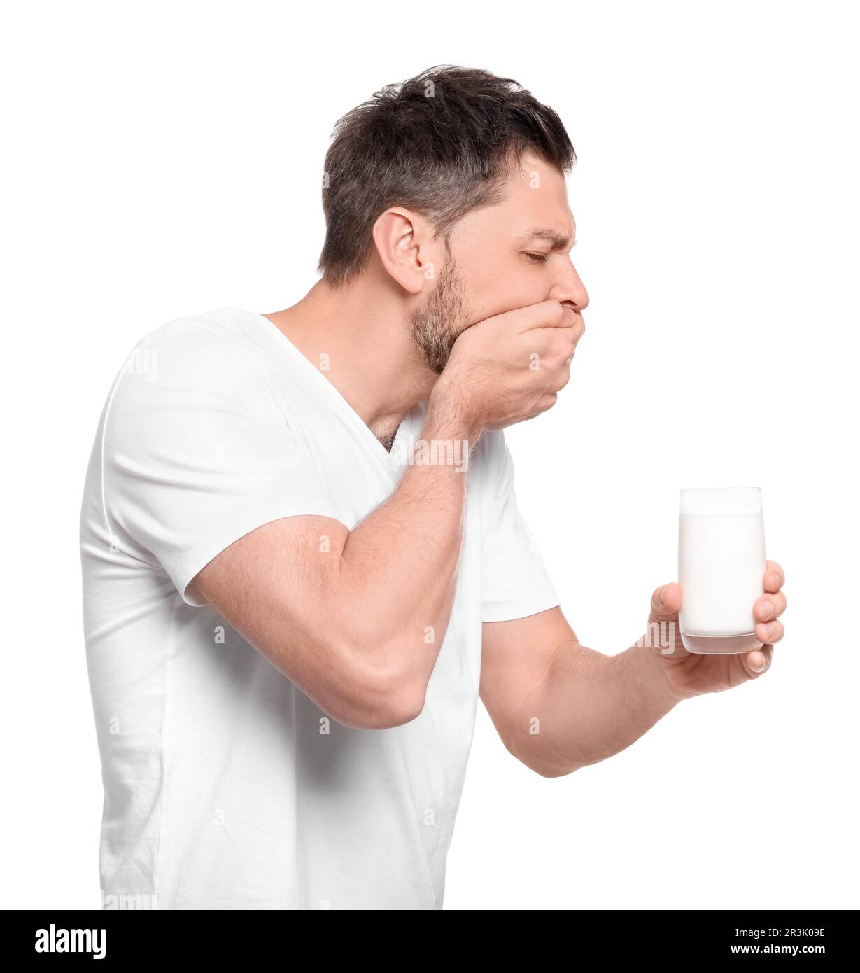 Man with glass of milk suffering from lactose intolerance on white ...