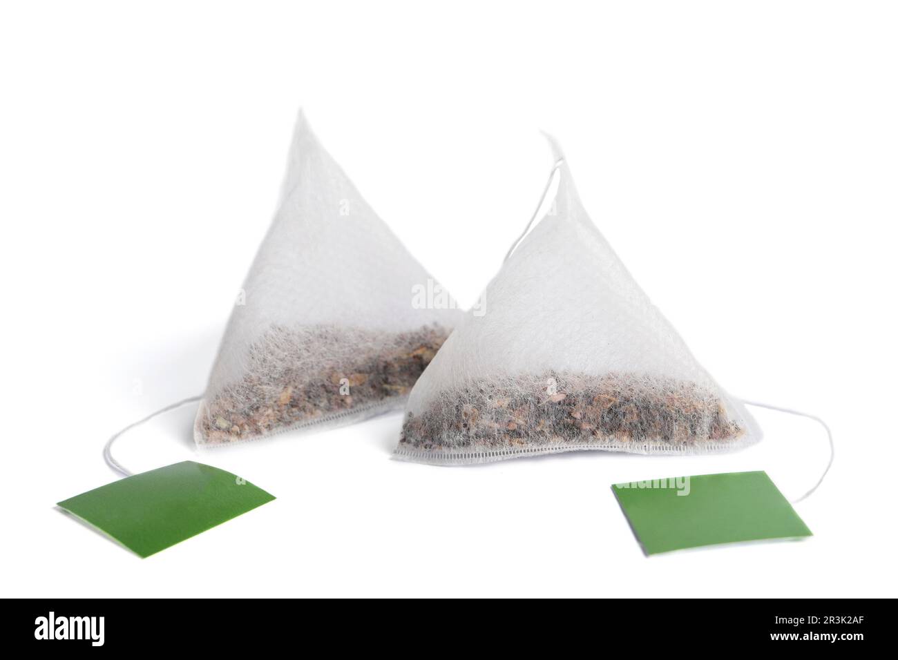 Paper tea bags with tags on white background Stock Photo - Alamy