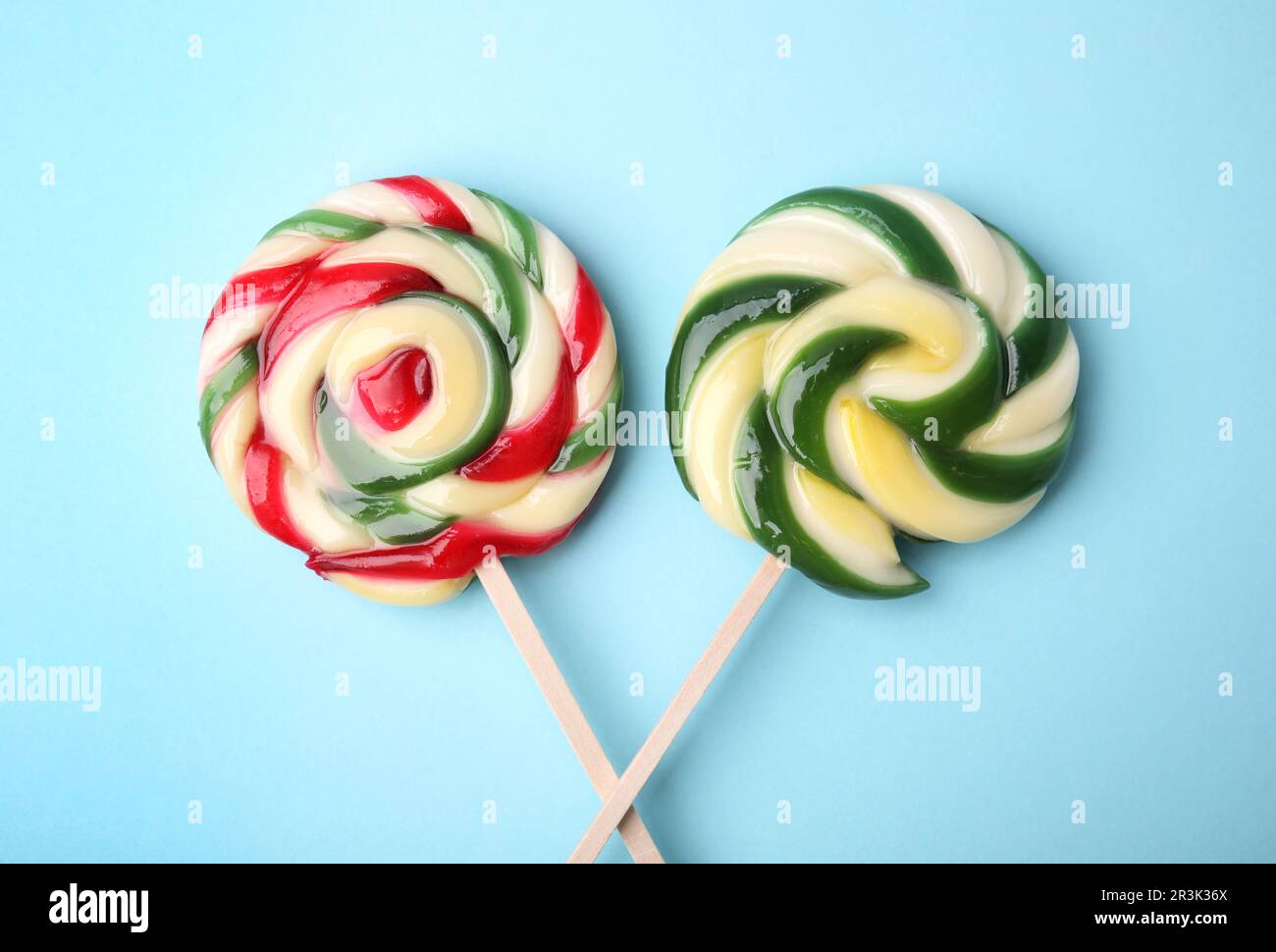 Colorful lollipops on light blue background, flat lay Stock Photo - Alamy