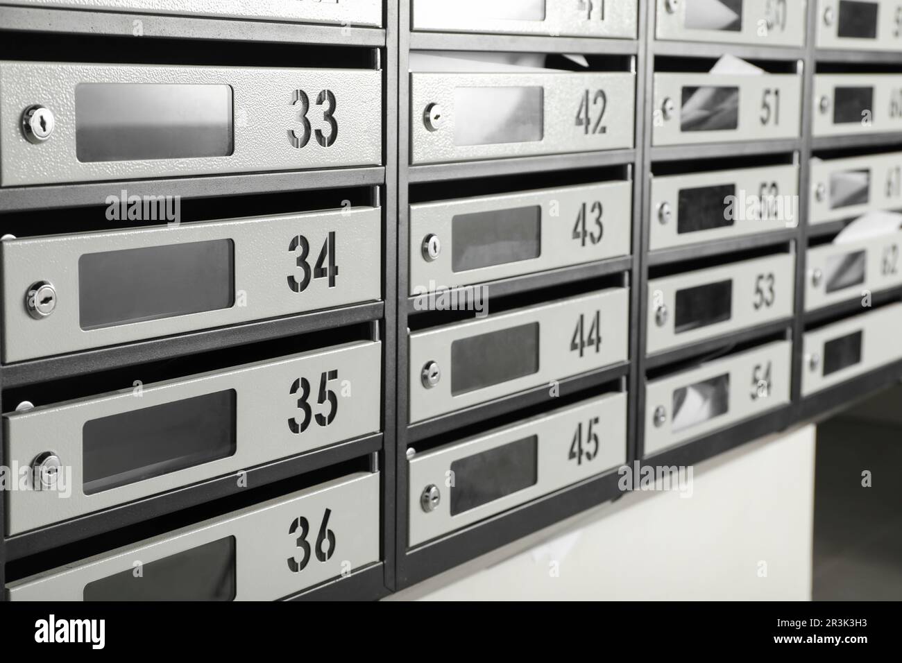 New mailboxes with keyholes, numbers and receipts in post office Stock ...