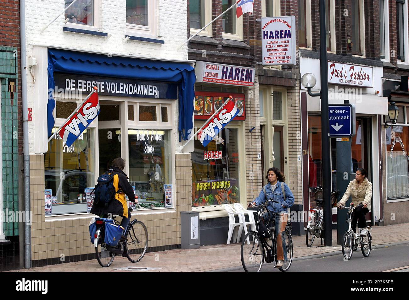 Netherlands, Utrecht Dutch fish shop between two shops with immigrant ...