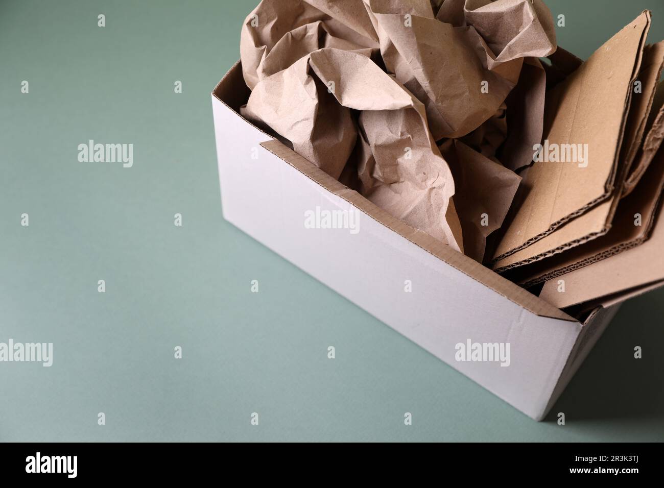 Box of waste paper on grey table, space for text Stock Photo - Alamy